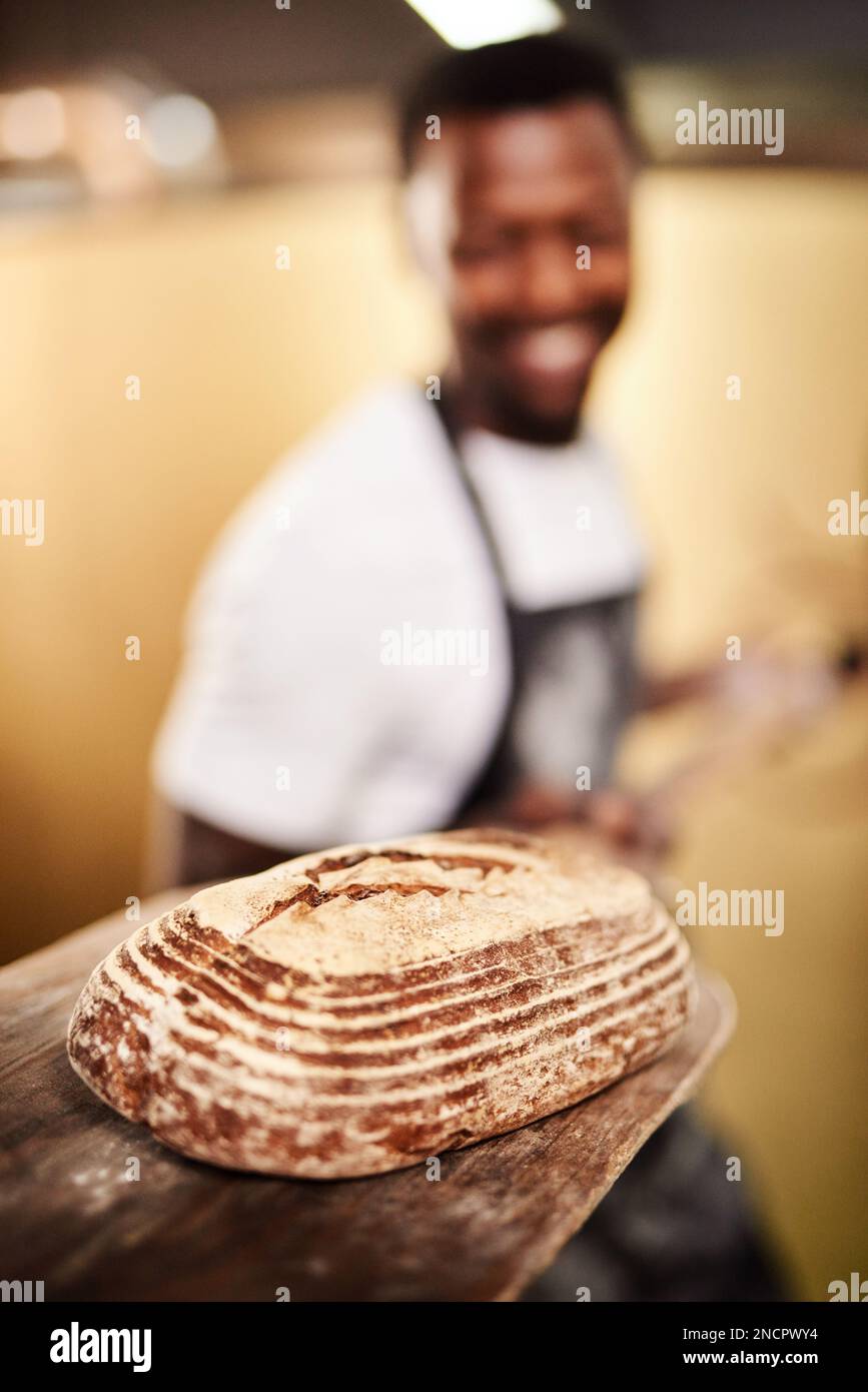 This is what my customers line up for. a male baker removing freshly ...