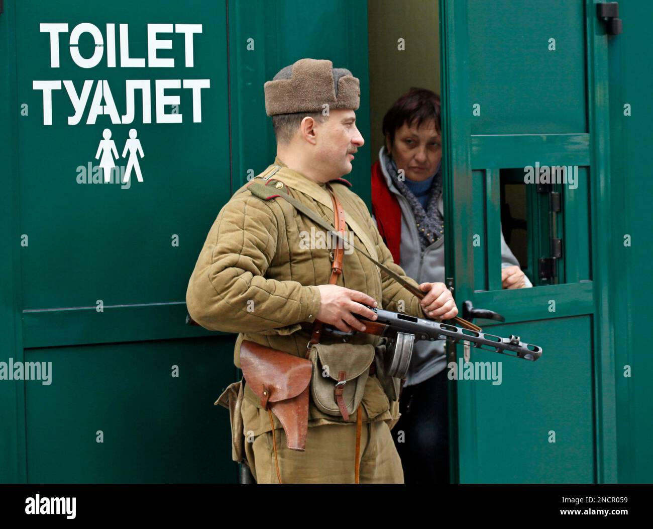 An activist dressed in a WWII Soviet military uniform waits for his ...