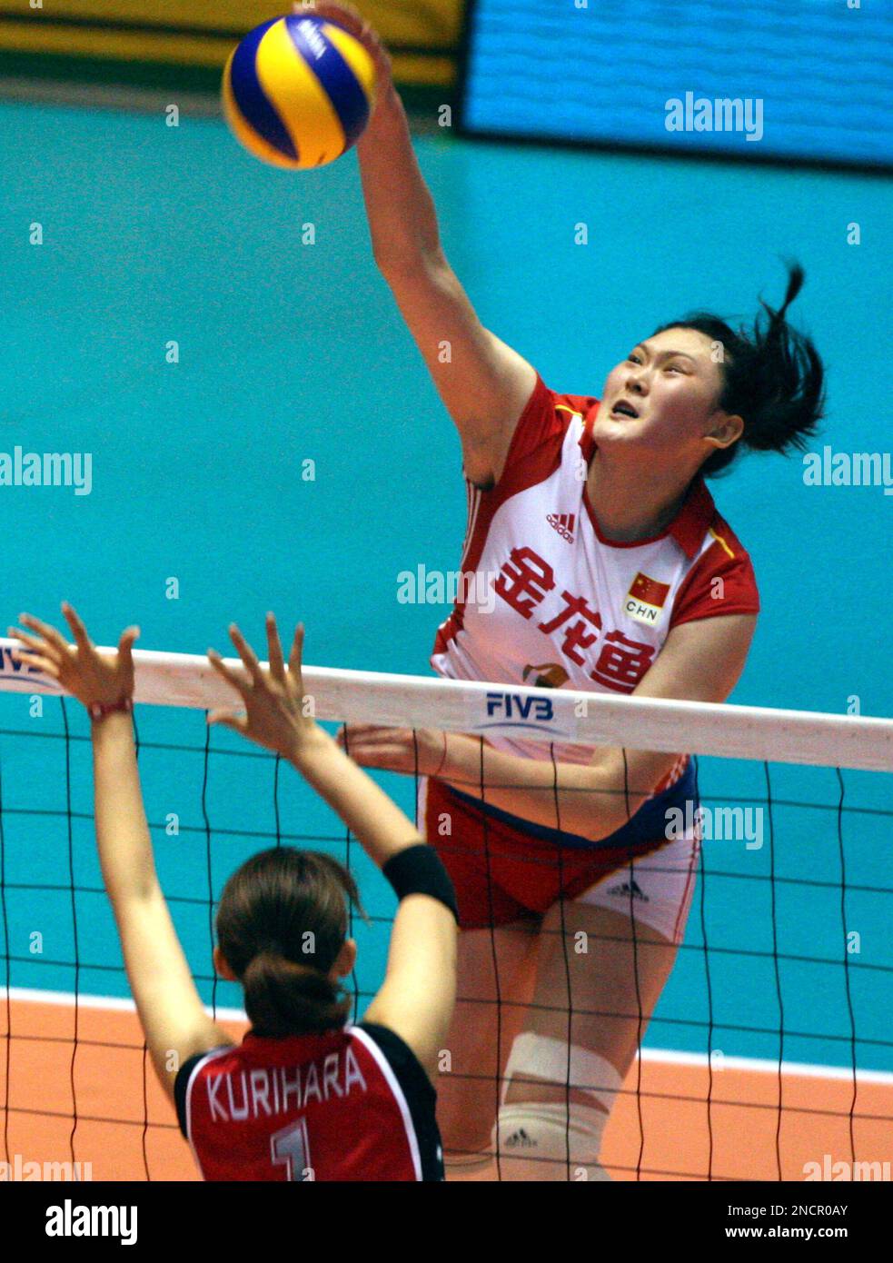 Wang Yimei of China spikes the ball against Megumi Kurihara of Japan ...