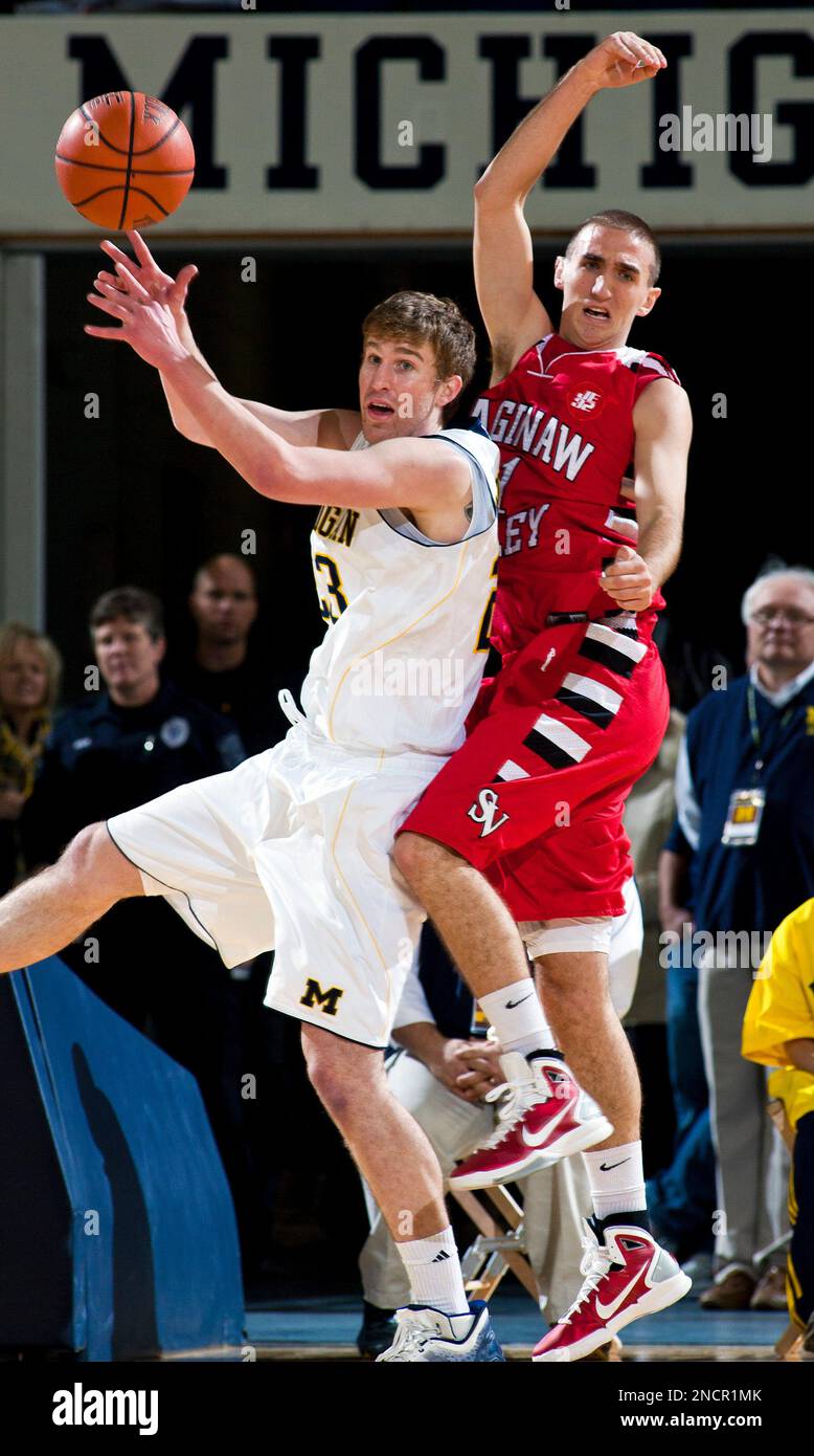 Michigan forward Evan Smotrycz, left, grabs a rebound from Saginaw ...