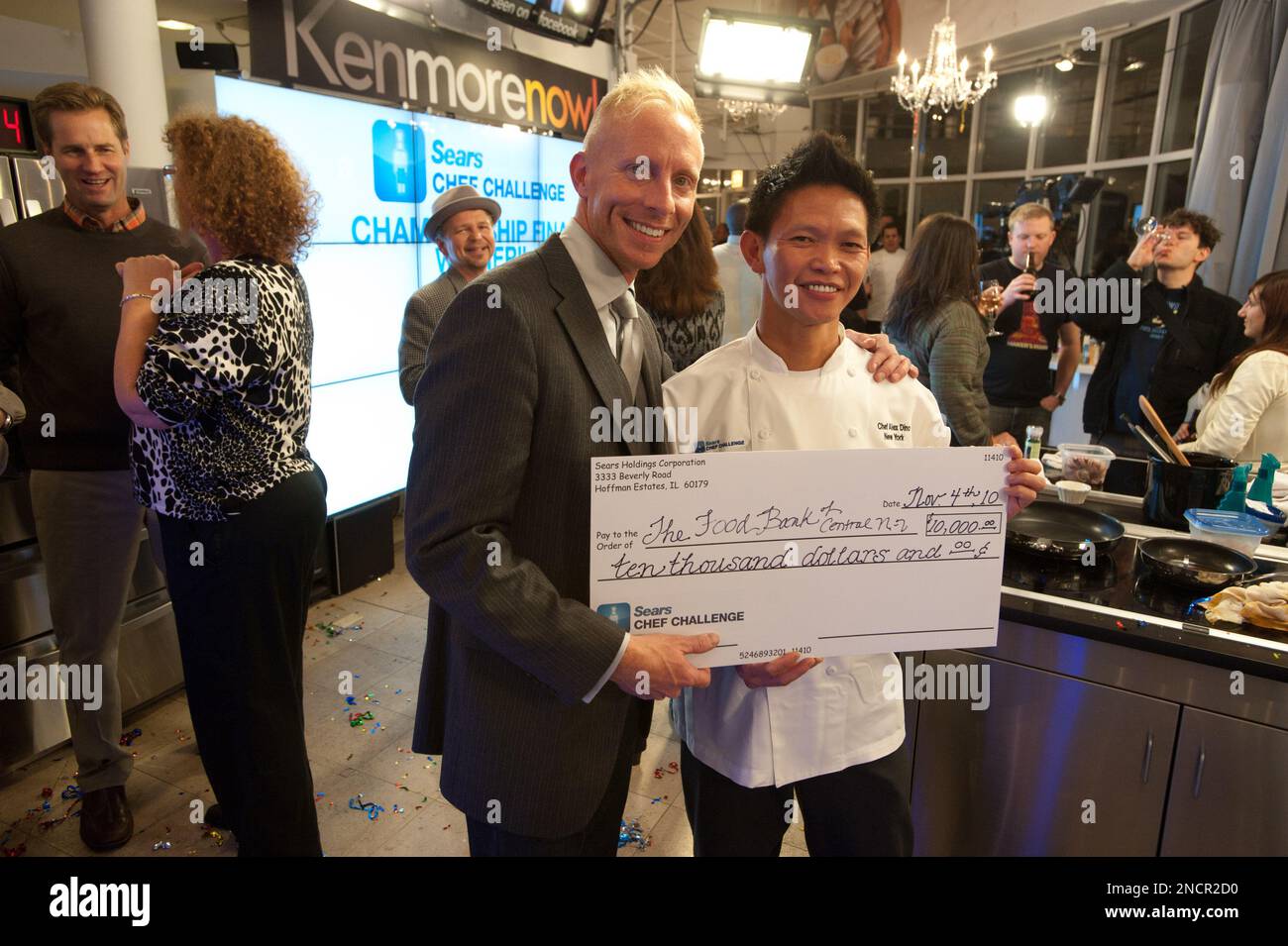 Sears executive, Shawn Pauli (left), presents a check to Chef Alex Dino ...
