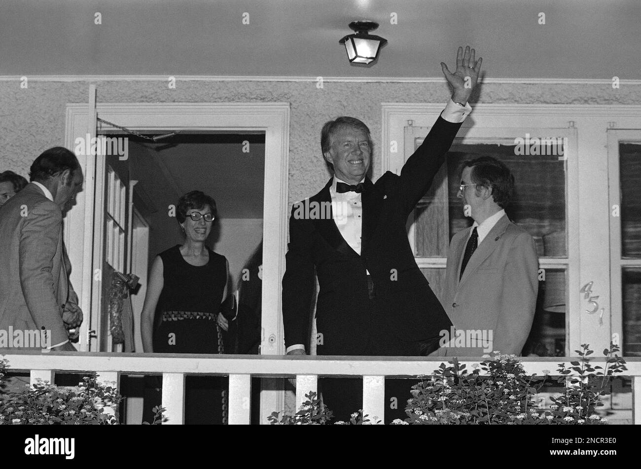 President Jimmy Carter waves from front porch of the James Wall home in ...