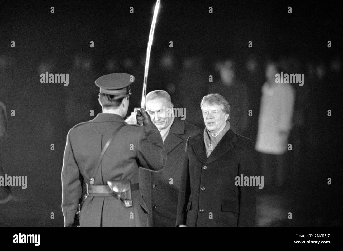 The commander of the Polish Honor Guard salutes President Jimmy Carter ...