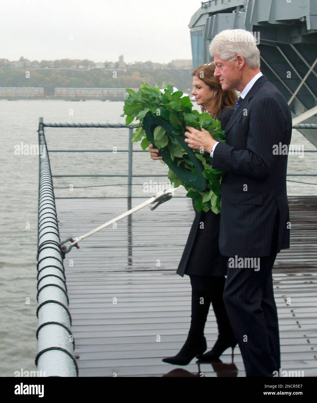 Dalia Rabin-Pelosoff, left, carries a wreath with former President Bill ...