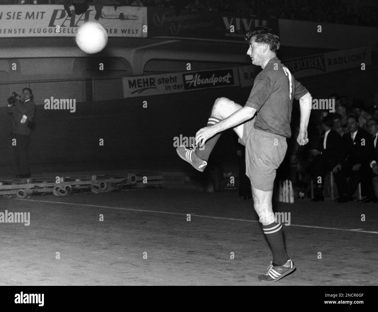 Fritz Walter, captain of the German national soccer team kicks a ball ...