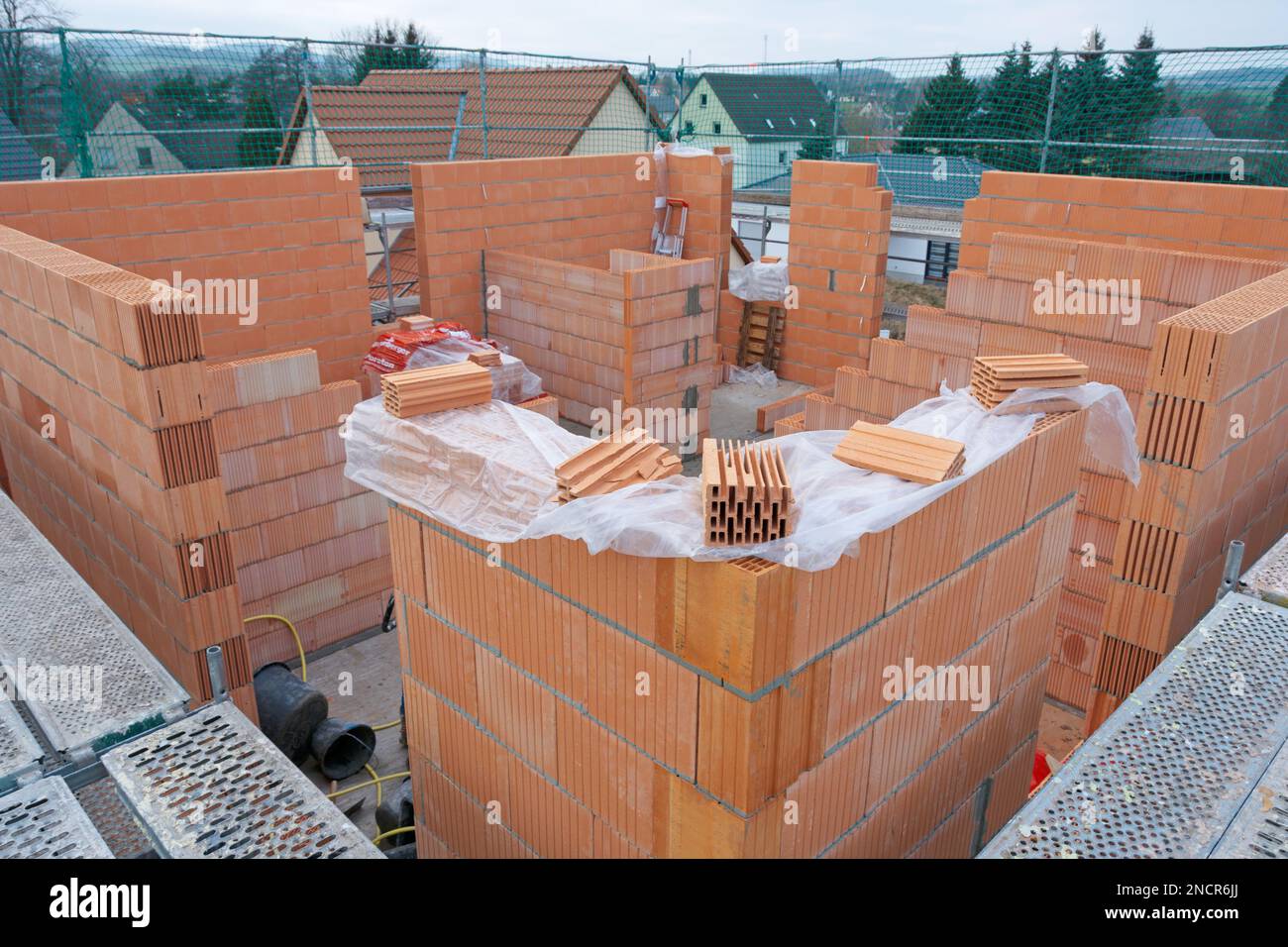 Scaffolded single-family house under construction Stock Photo - Alamy