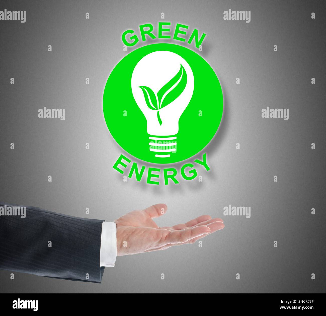 Green energy concept levitating above a hand on grey background Stock ...