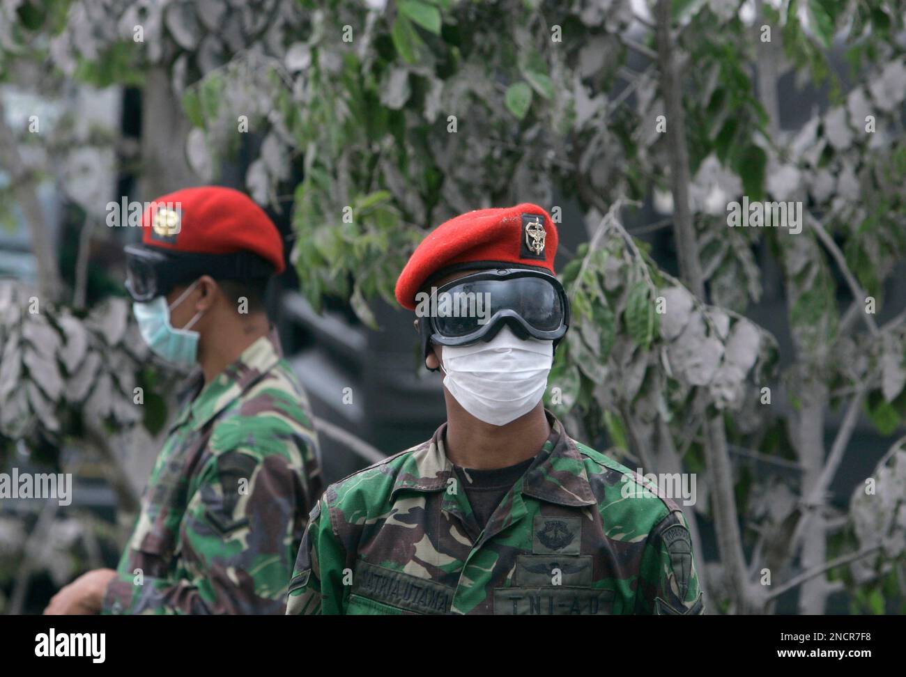 Indonesian soldiers wear masks and goggles to protect themselves from ...