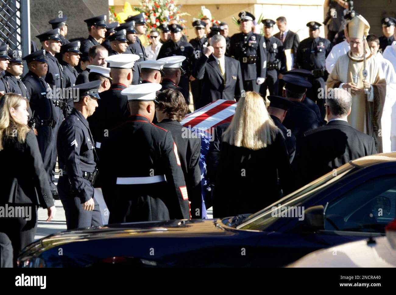 Marine and police pallbearers carry the casket of Los Angeles Police ...