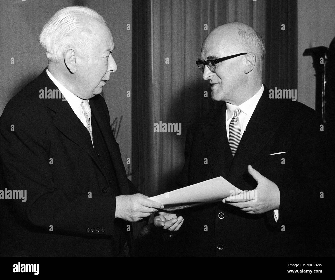 German President Theodor Heuss, left, hands the letter of appointment ...