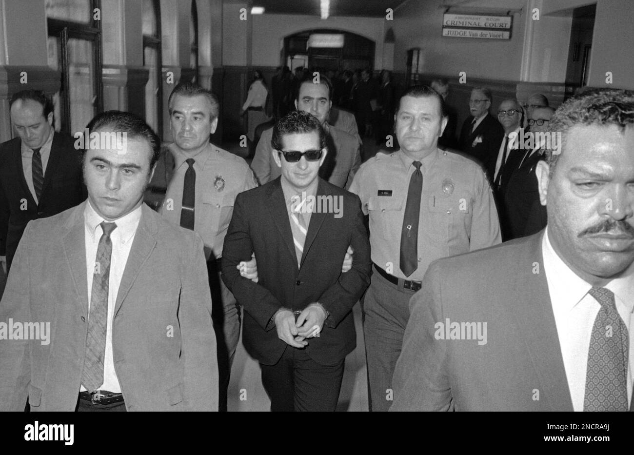 Stanley B. Hoss, flanked by policemen, is escorted from Pittsburgh ...