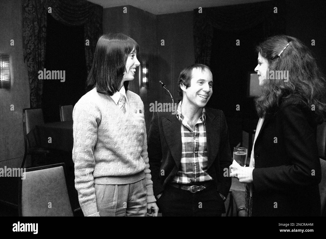 Paul Simon, formerly of Simon and Garfunkel, chats with his girlfriend ...
