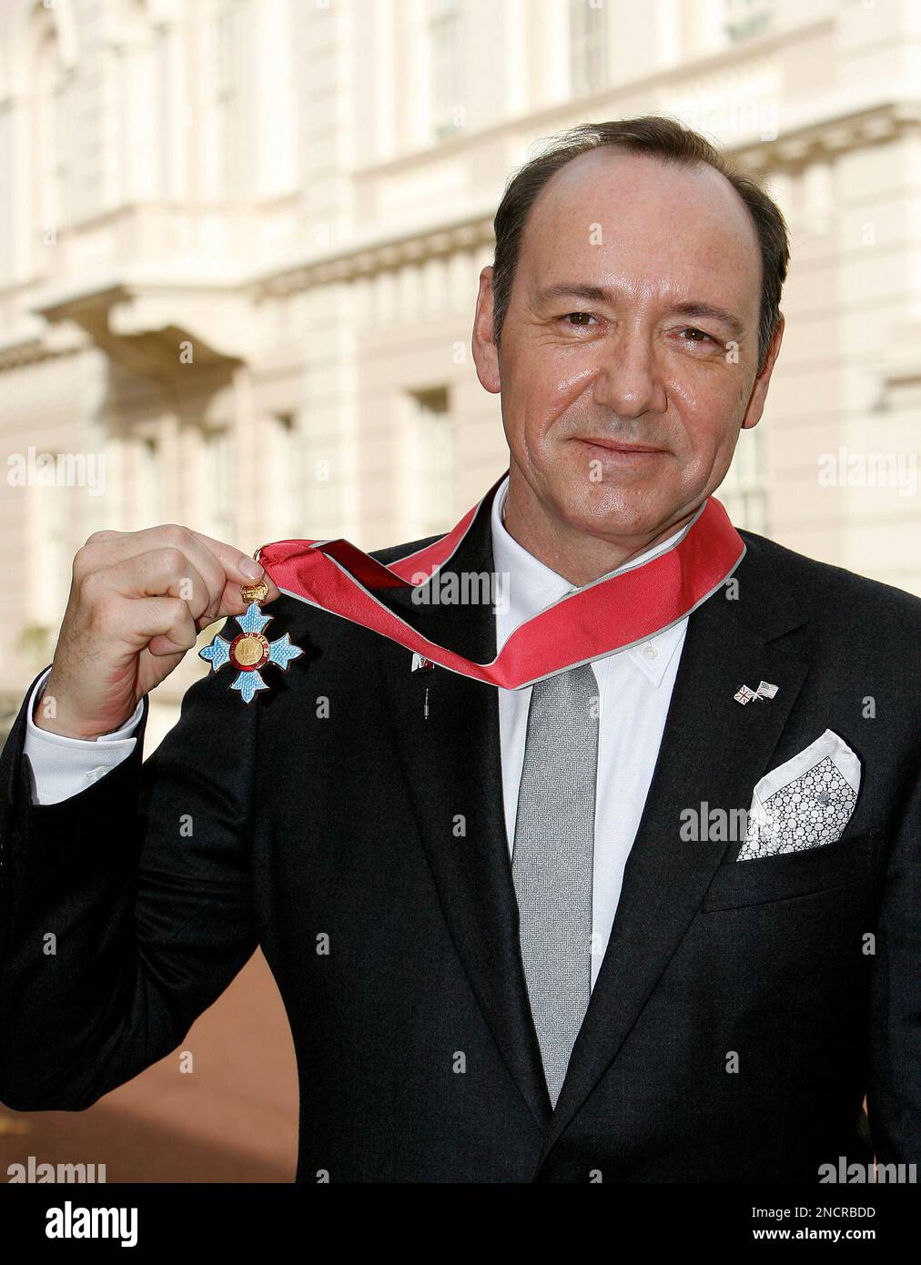 U.S. actor Kevin Spacey poses for photographs with his honorary CBE ...