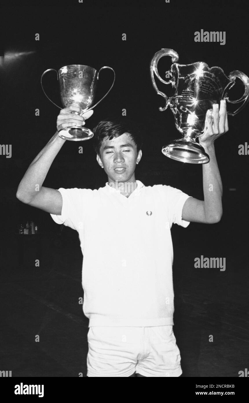 Indonesian Rudy Hartono holds aloft his trophies after winning the All ...