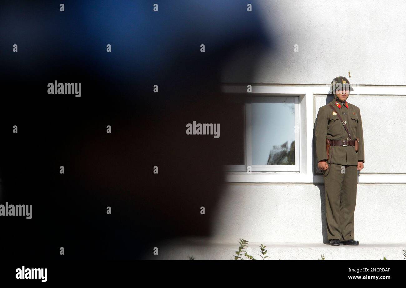 A North Korean soldier, right, looks at the south side as South Korean ...