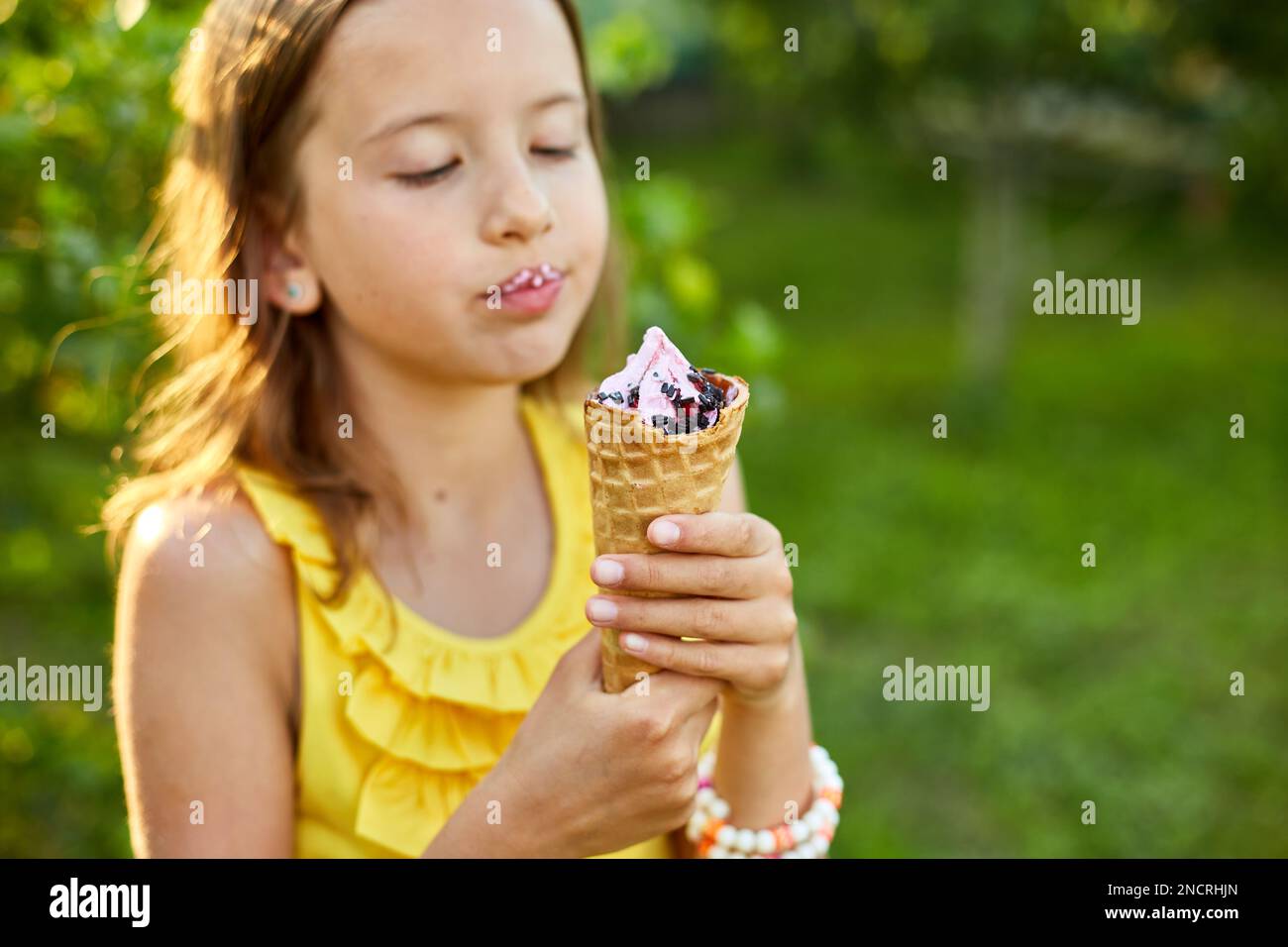 Happy girl with braces eating italian ice cream cone smiling while ...