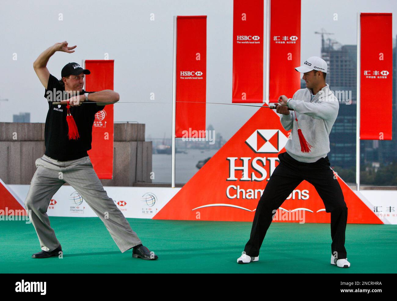 Phil Mickelson of Britain, left, and Martin Kaymer of Germany strike a ...