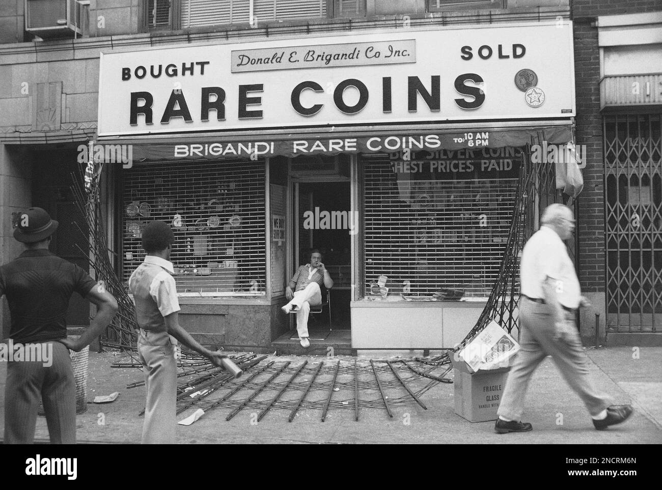 The owner of midtown Manhattan coin shop sits disconsolately in his ...