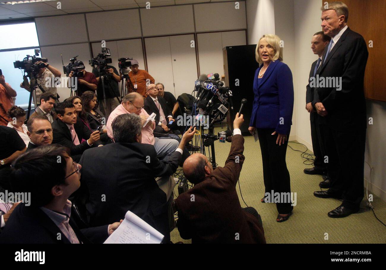 Arizona Gov. Jan Brewer, center right, speaks at a news conference at a ...