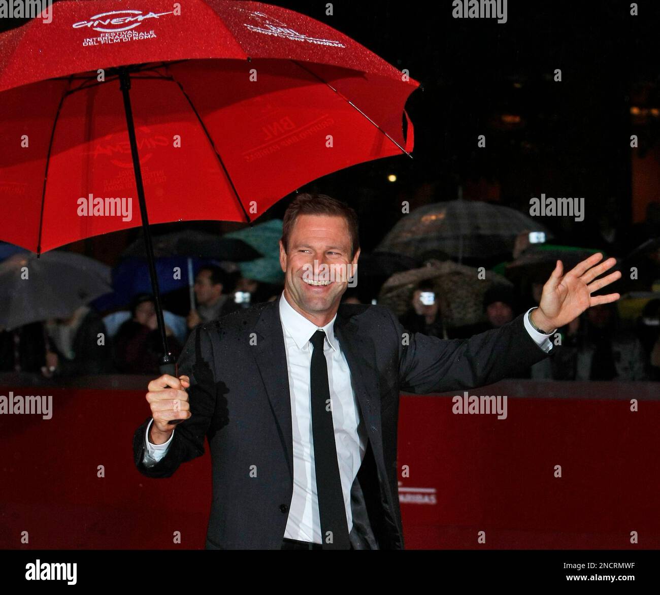 US actor Aaron Eckhart waves to fans as he arrives on the red carpet to ...