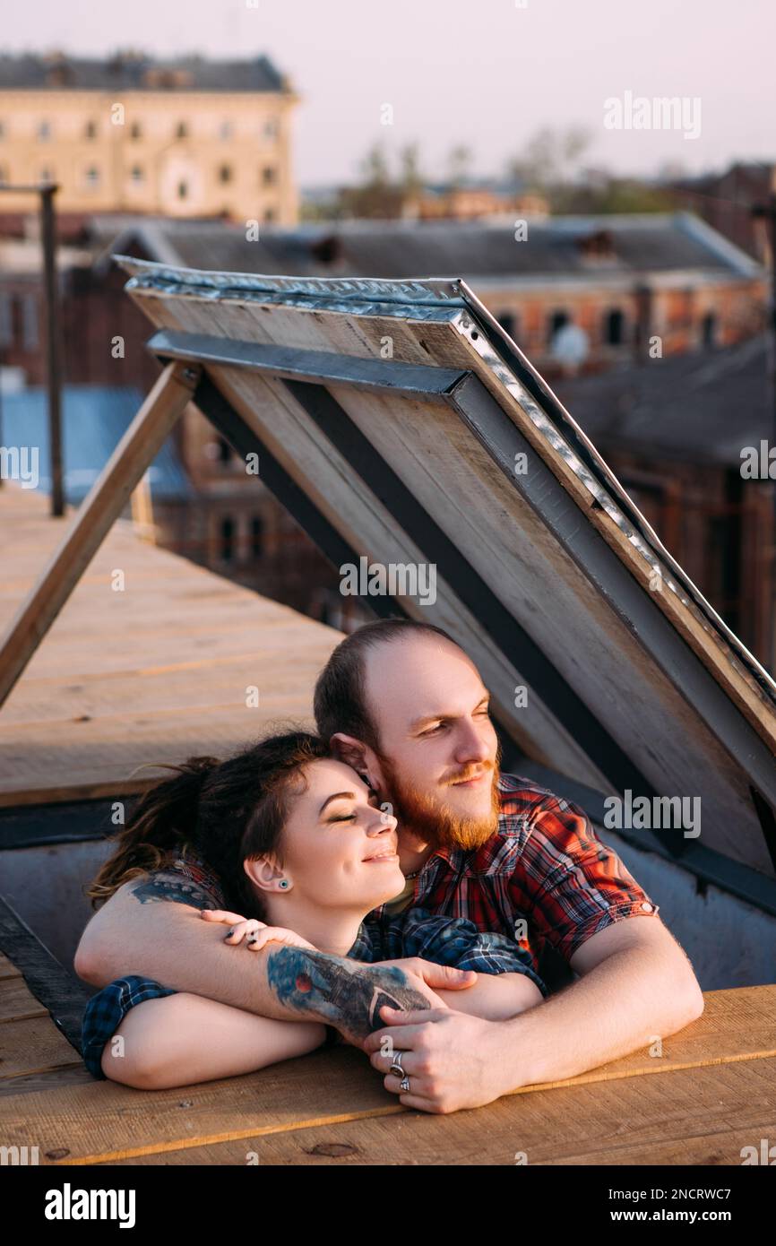 Romantic date on roof. Couple enjoying sunset Stock Photo - Alamy