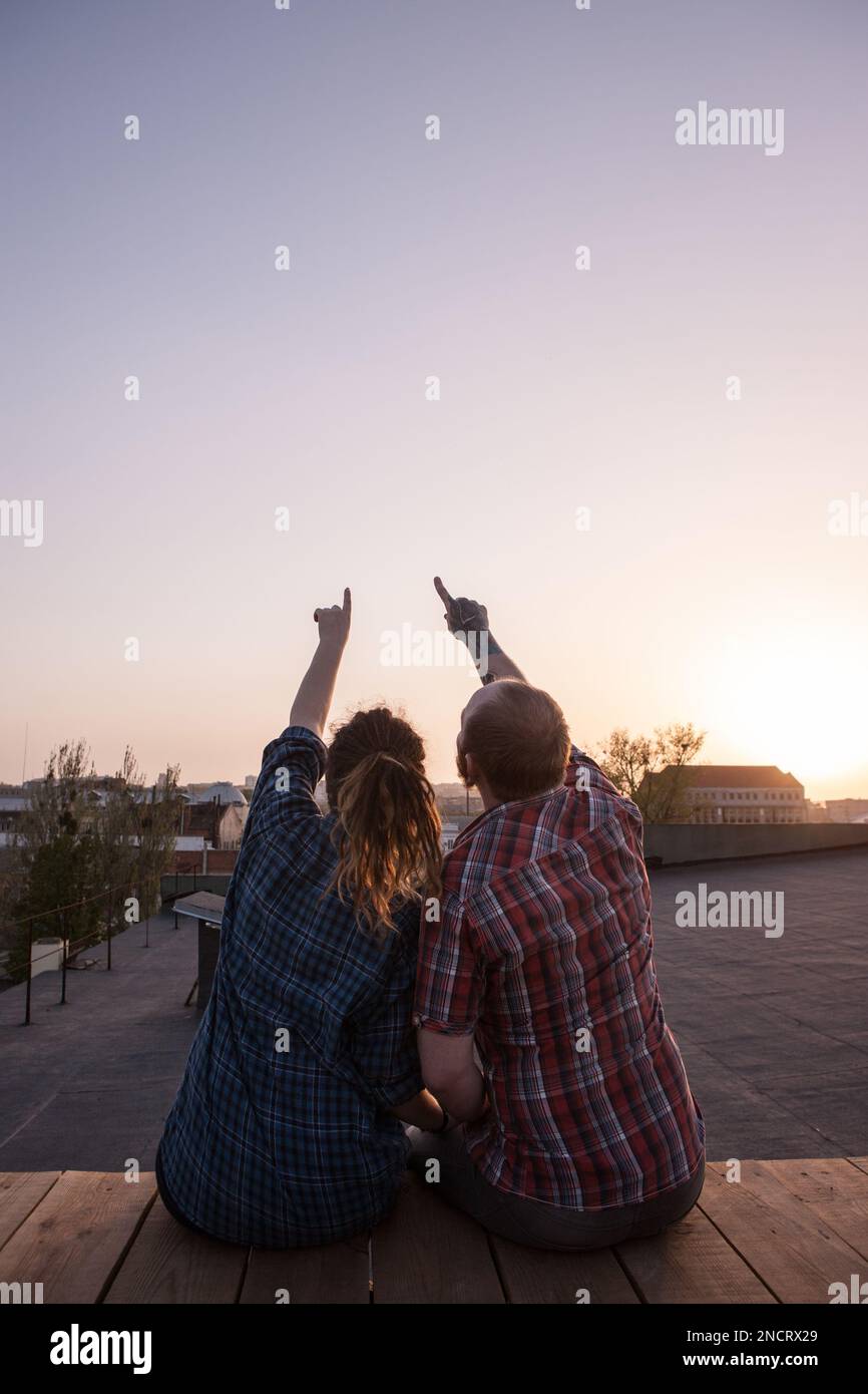Two people sit on roof hi-res stock photography and images - Alamy