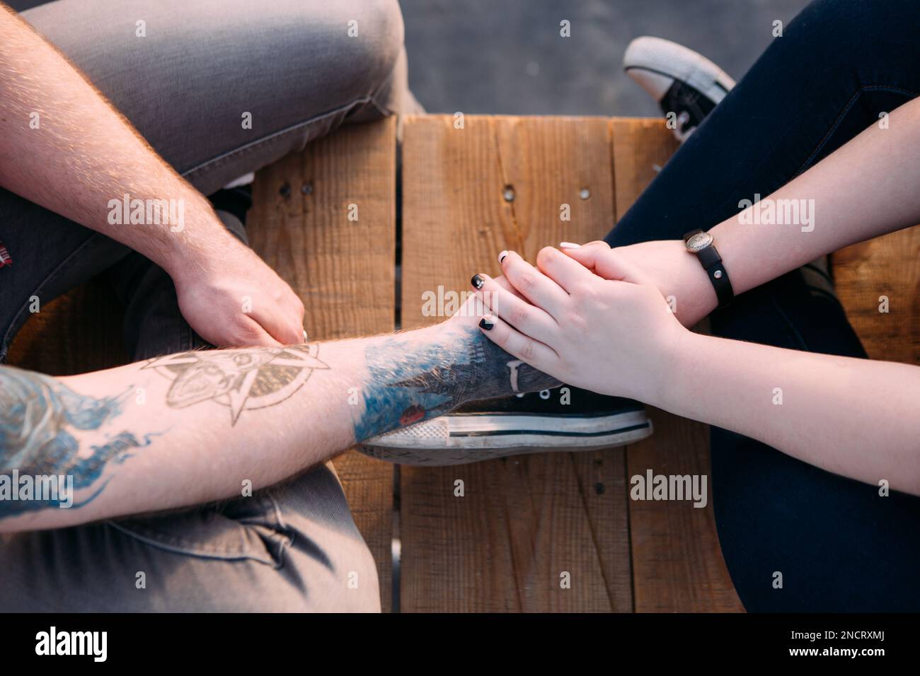 Sensitive romantic bound. Couple holding hands Stock Photo - Alamy