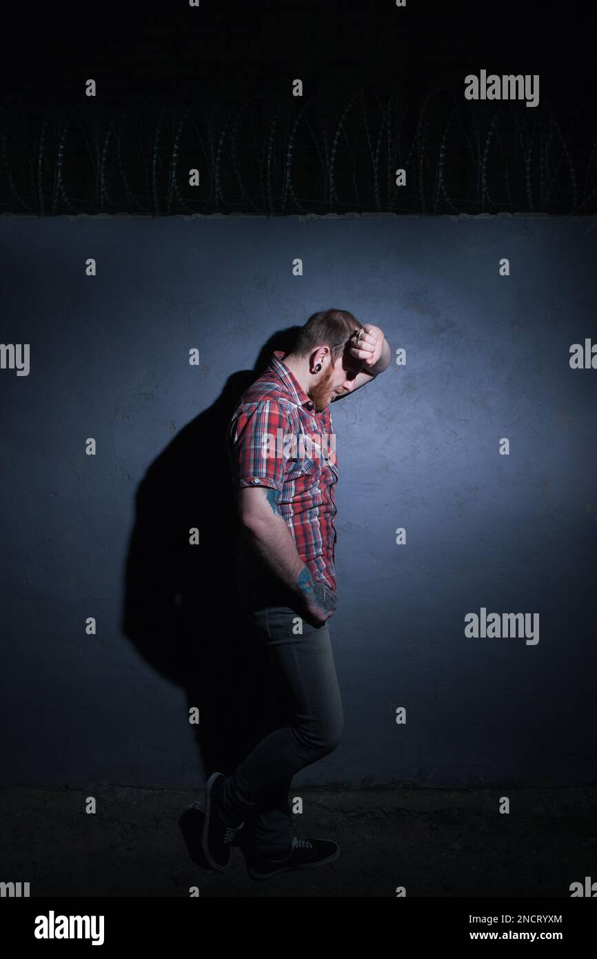 Problems in life. Tired male in prison Stock Photo - Alamy