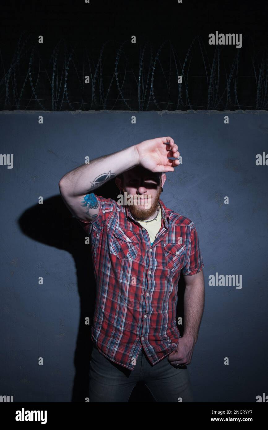 Confident male prisoner. Bright light in face Stock Photo - Alamy
