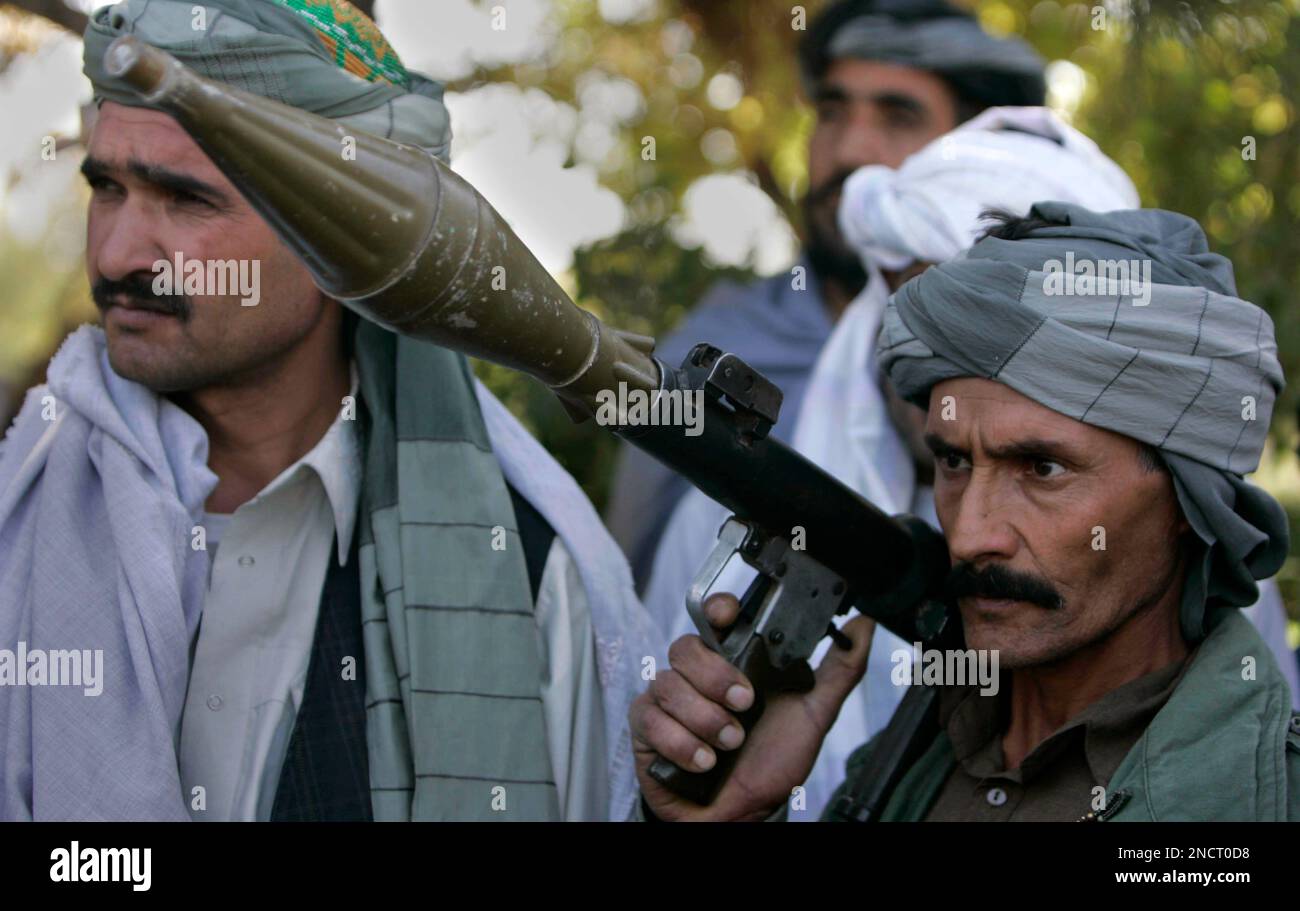 A former Taliban fighter carries a rocket launcher before surrendering ...