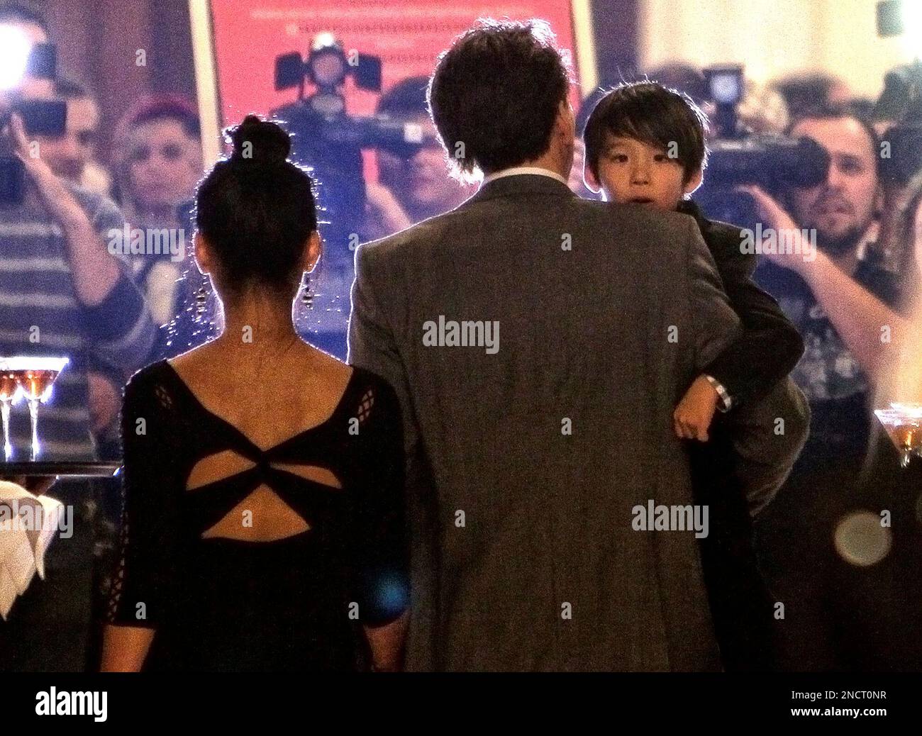 US actor Nicholas Cage, right, holds his son Kal-el as he faces media ...