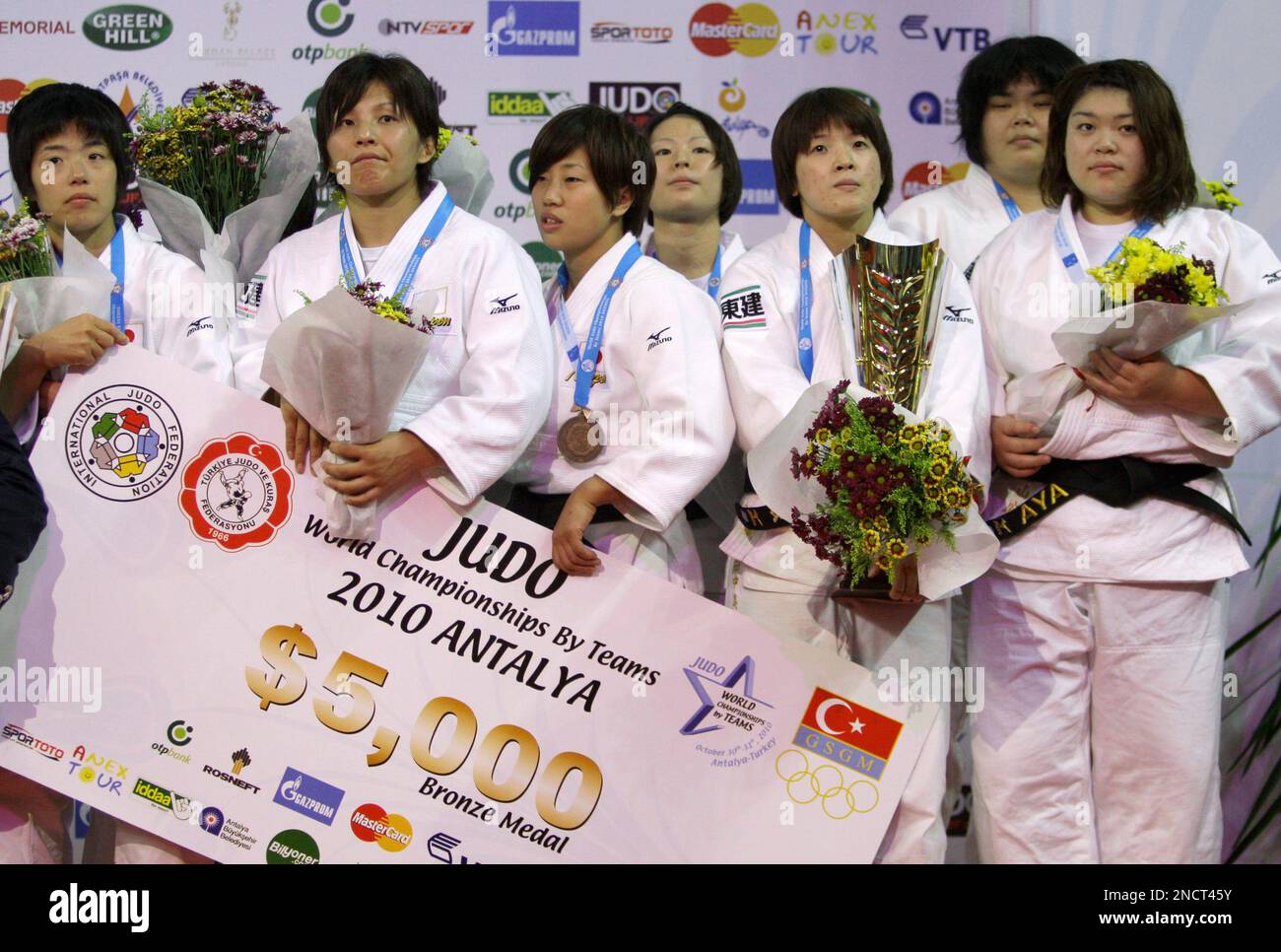 Bronze medalist Japan women judo team members celebrate on the podium ...