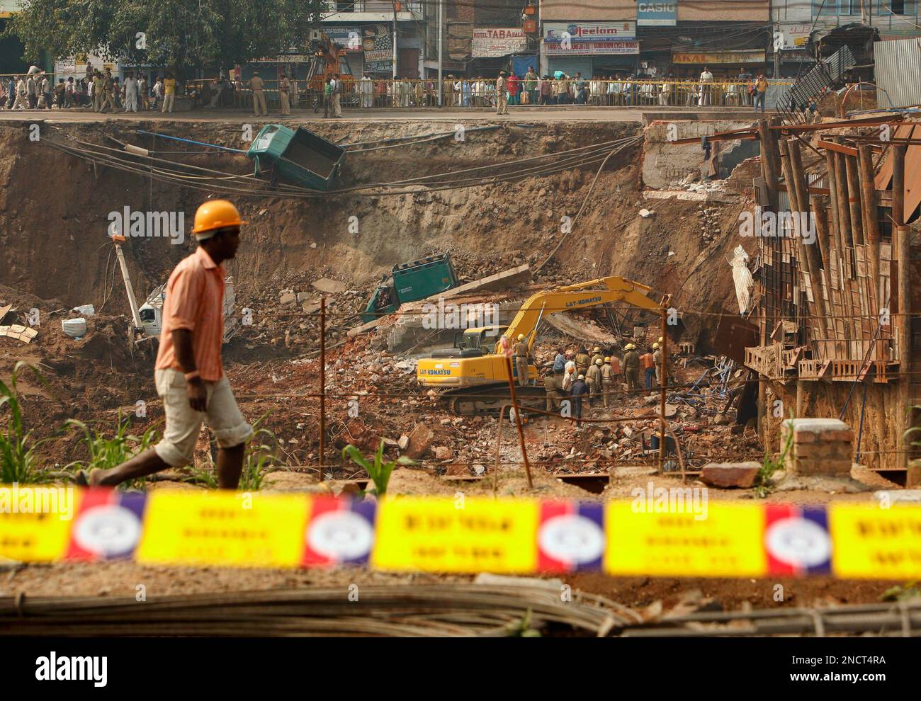 Indian rescue workers and fire brigade personnel dig through rubble of ...