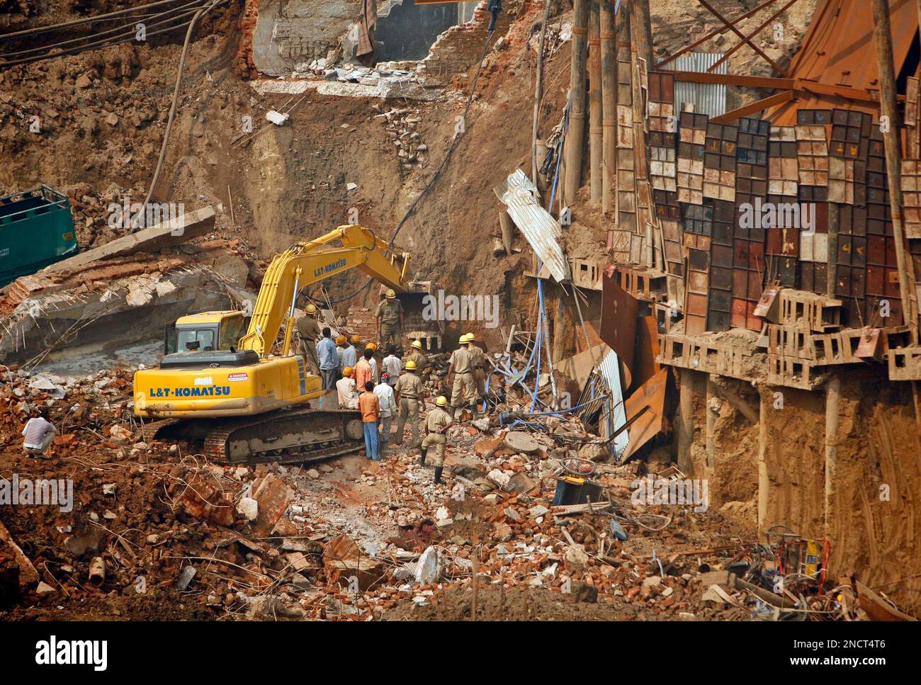 Indian rescue workers and fire brigade personnel dig through rubble of ...