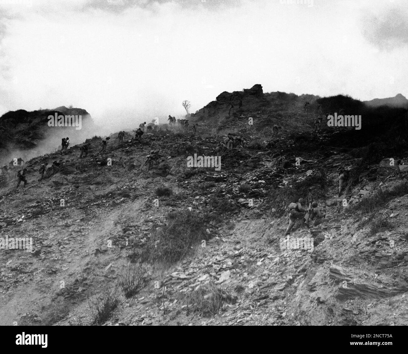 The uniforms of American soldiers blend into the landscape as they ...