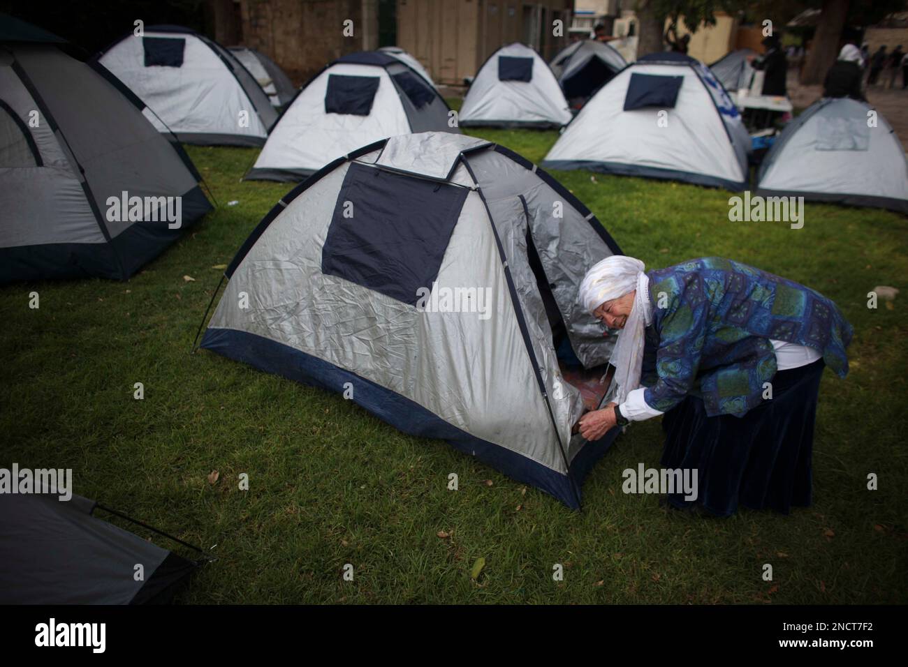 An Orthodox Jewish woman zips up her tent where she will spend the ...