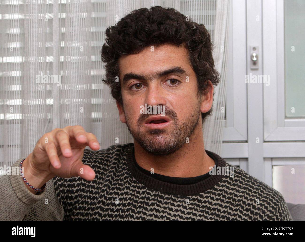 Chilean surfer Sebastian Carello gestures during an interview with The ...