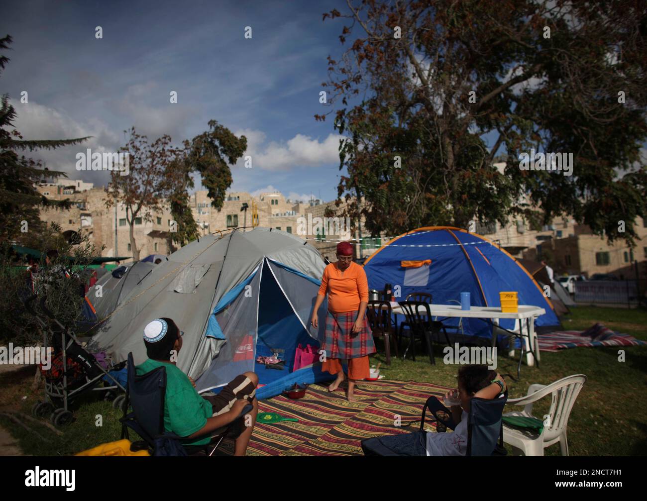 An Orthodox Jewish family gathers around their tent where they will ...