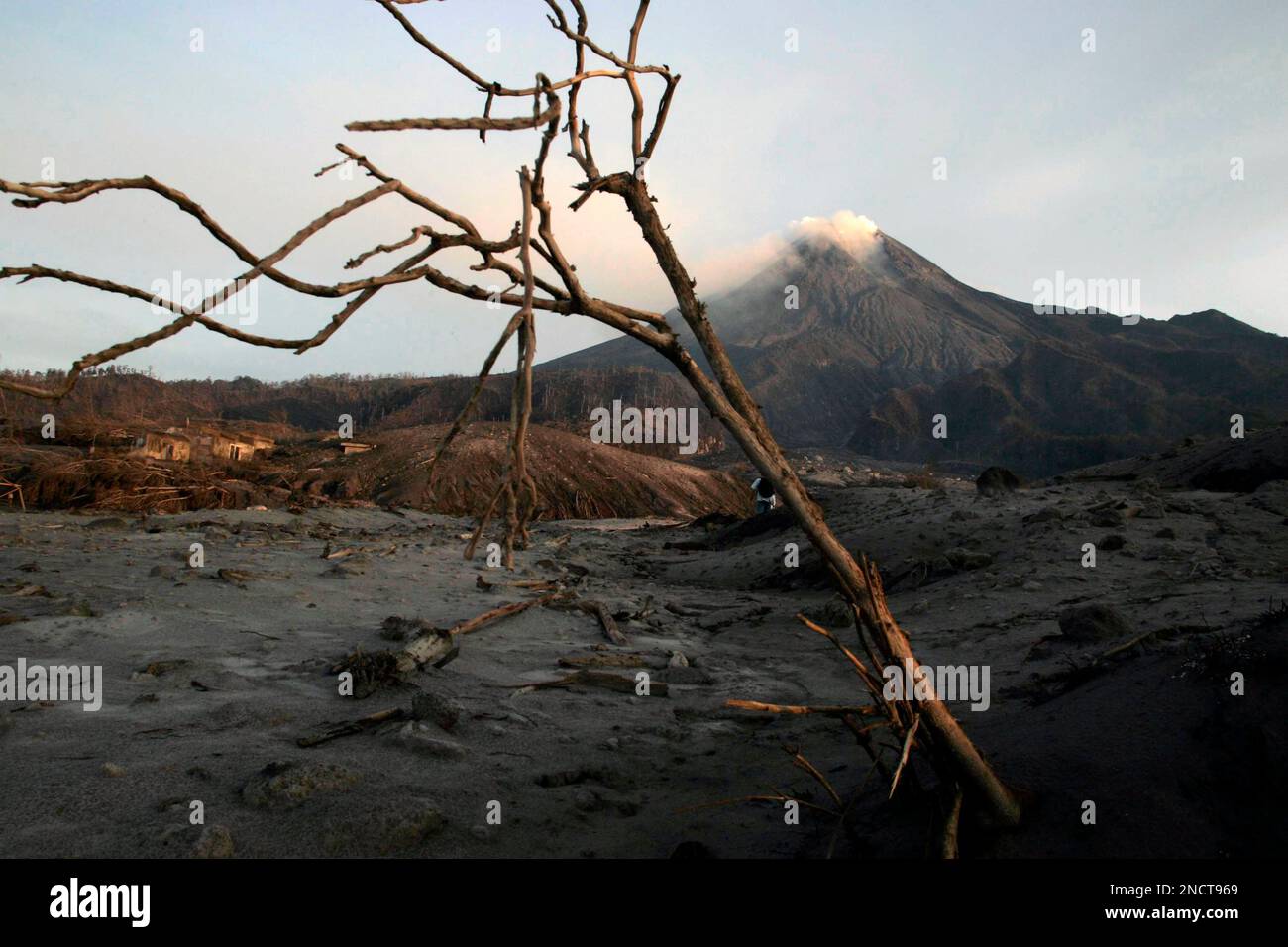 Mount Merapi spews volcanic smoke as debris from its previous eruption ...