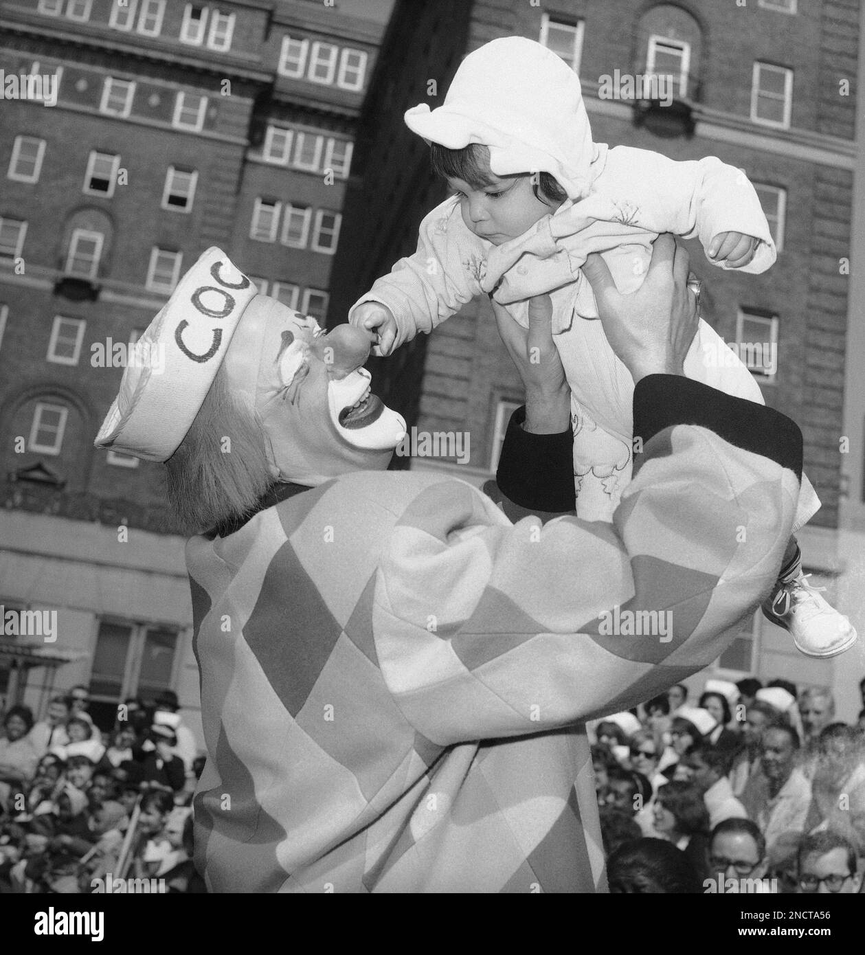 Finger tip on nose of Coco, the clown, one-year old Edgar (last name ...