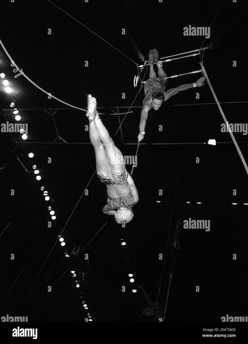 “The Platos,” trapeze artists from Denmark, perform one of their ...