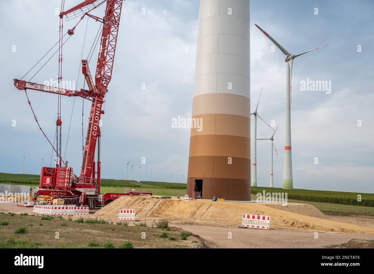 Construction site of a wind turbine, crane next to the tower of the ...