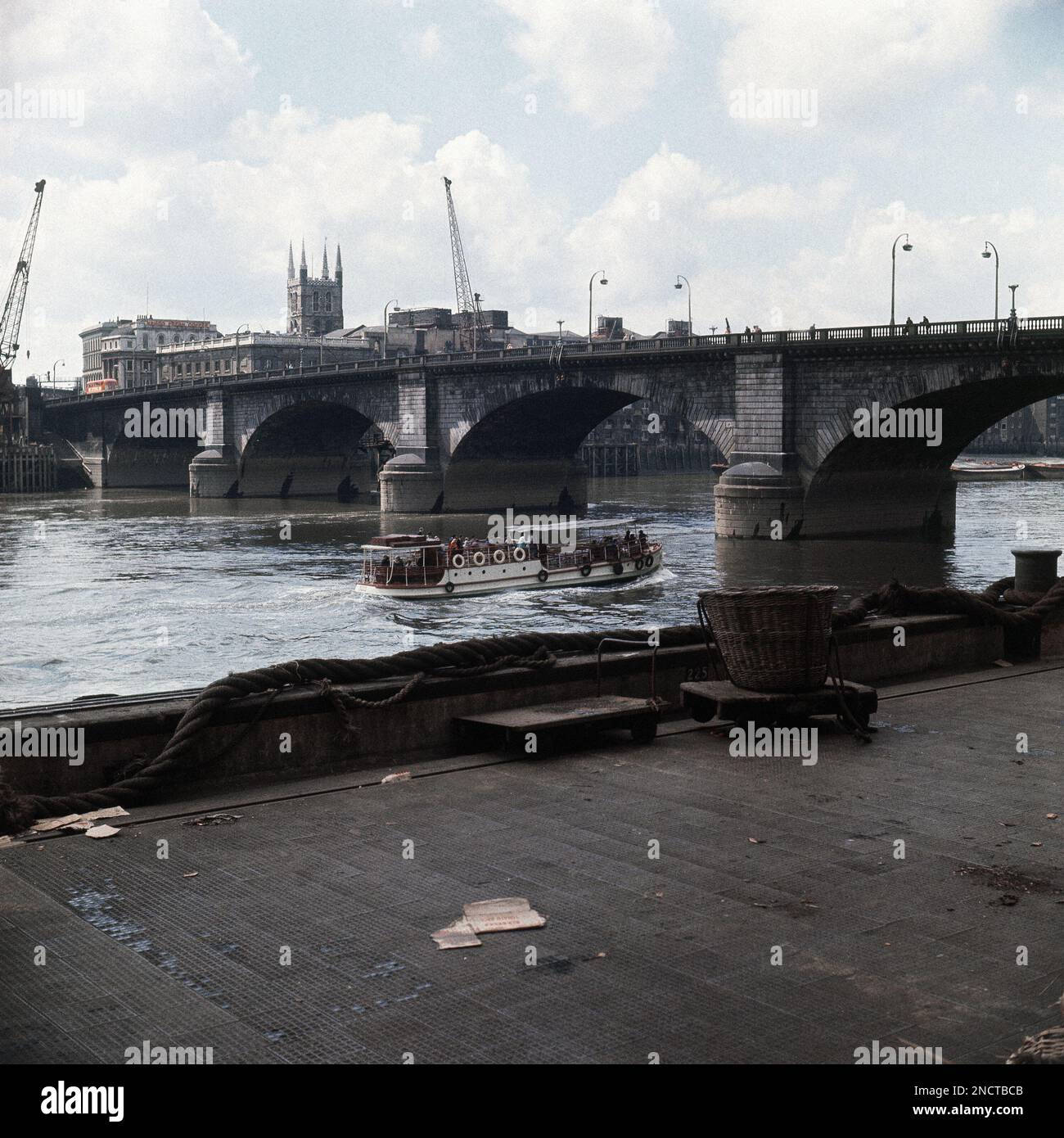 A boat passing under London Bridge on the River Thames in London on ...