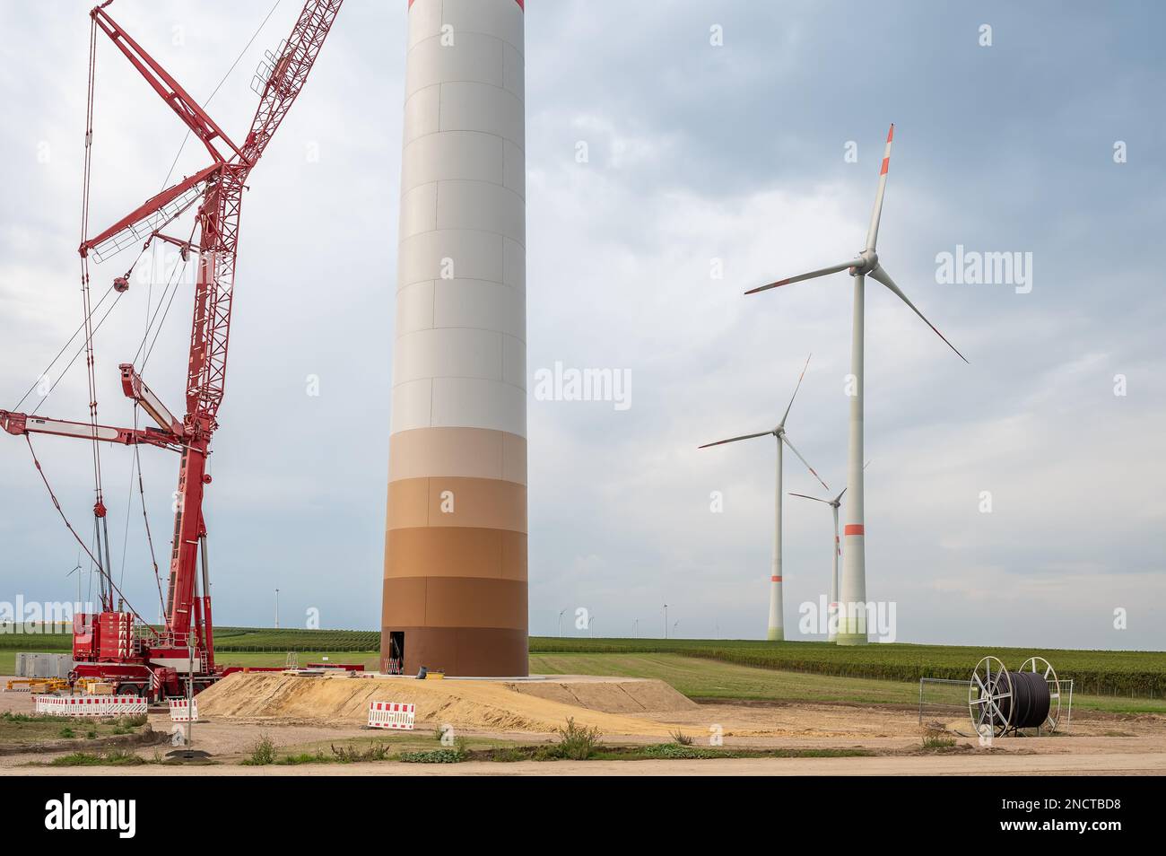 Construction site of a wind turbine, crane next to the tower of the ...