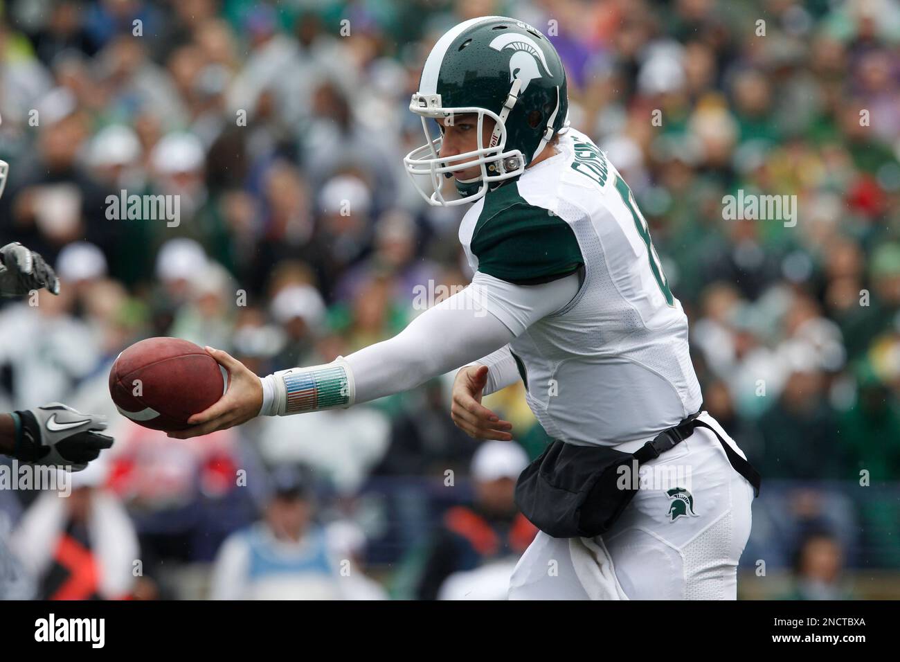 Michigan State quarterback Kirk Cousins drops off the ball against ...