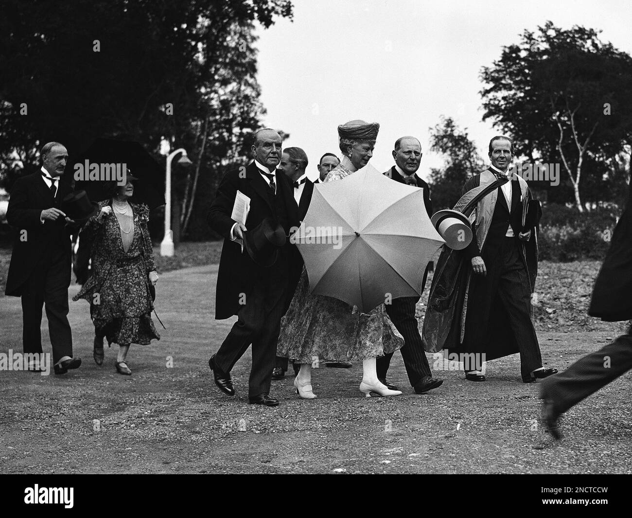 Britain's Queen Mary carrying a parasol as she walks through the ...