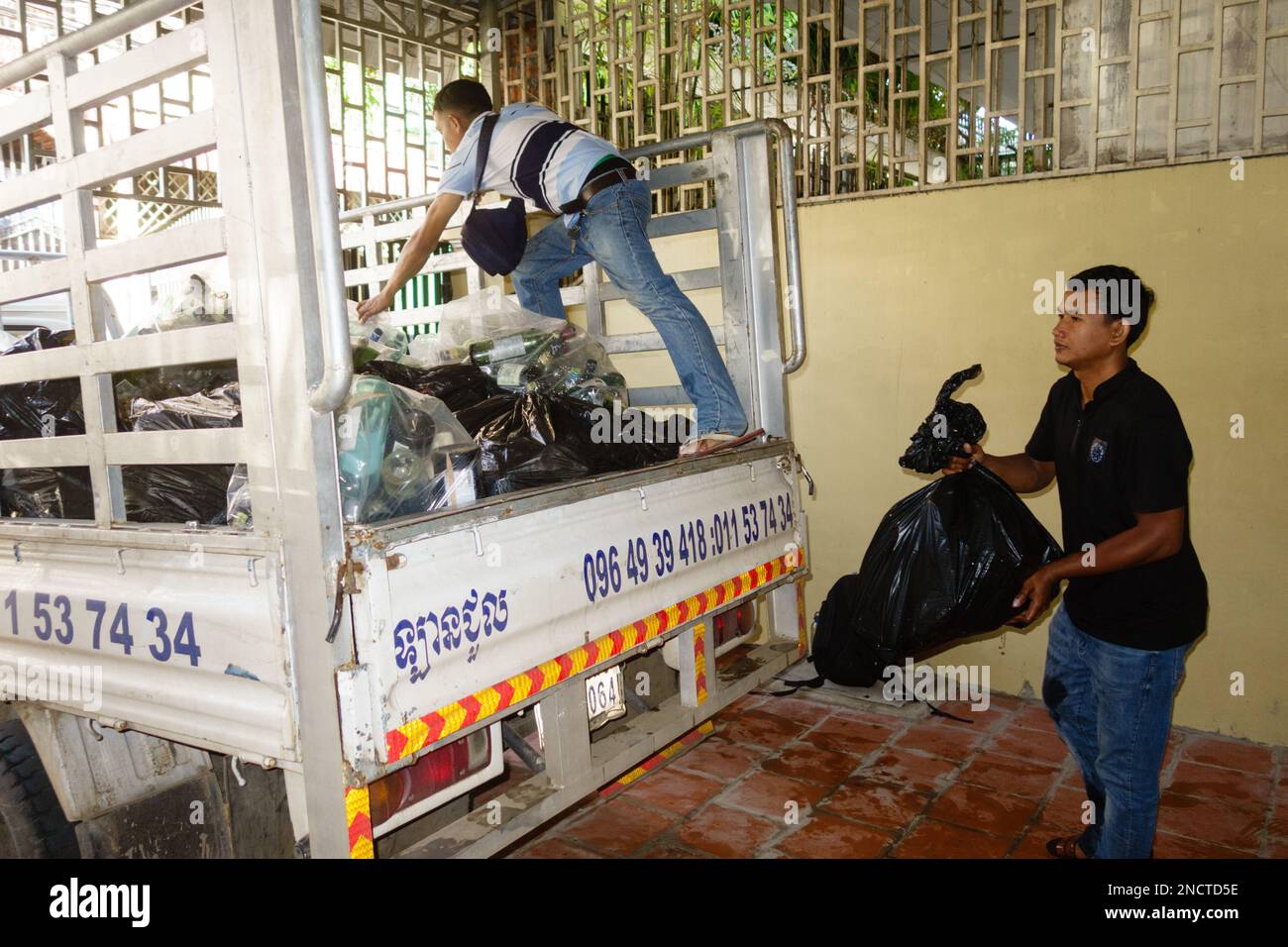 Volunteers in Phnom Penh, Cambodia collect recycling and transport it ...