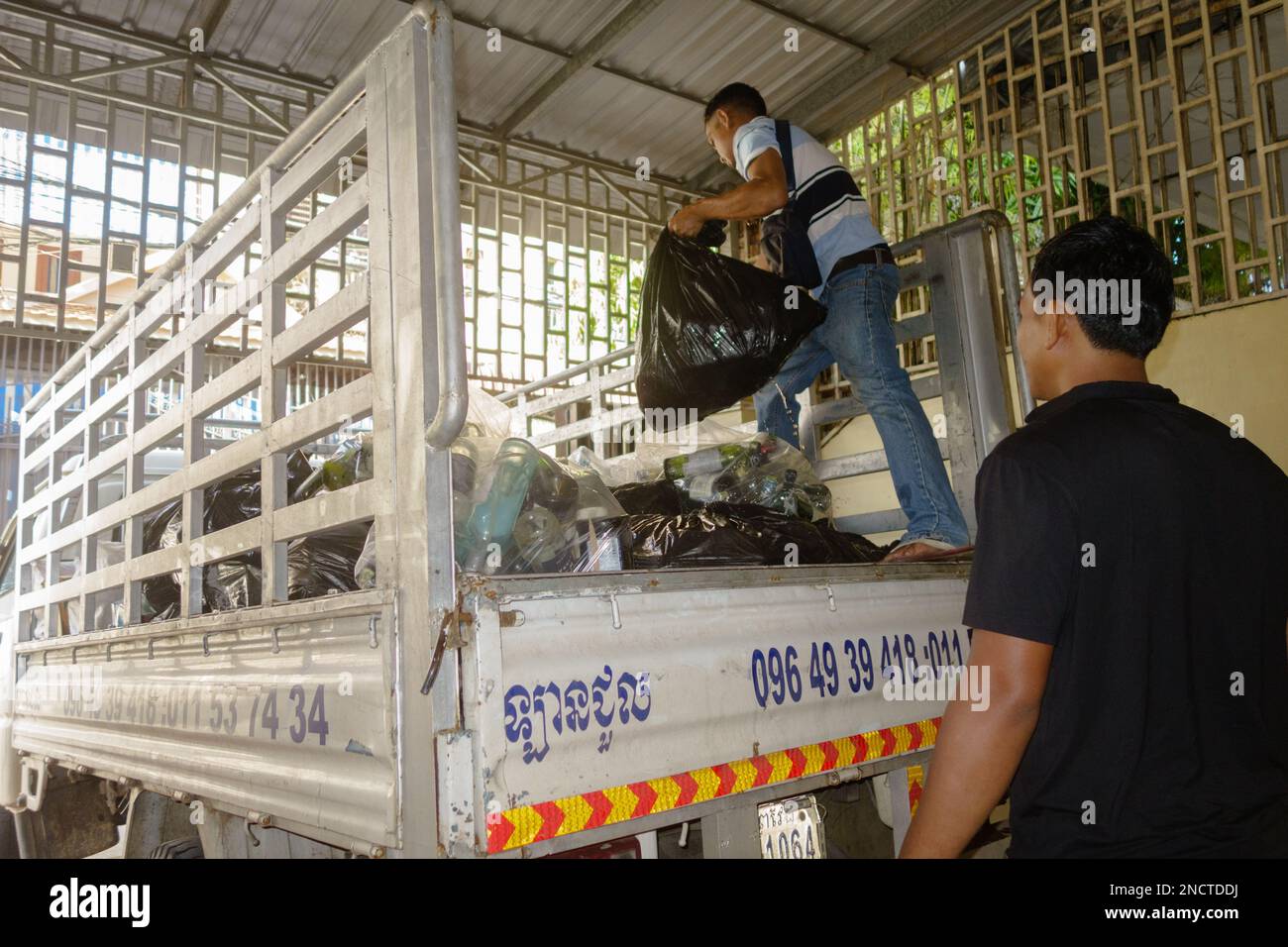 Volunteers in Phnom Penh, Cambodia collect recycling and transport it ...