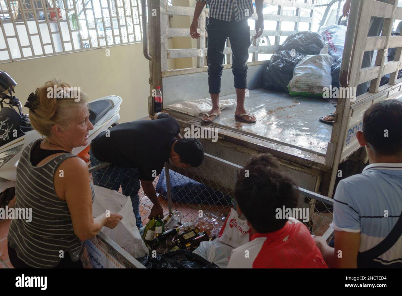 Volunteers in Phnom Penh, Cambodia collect recycling and transport it ...