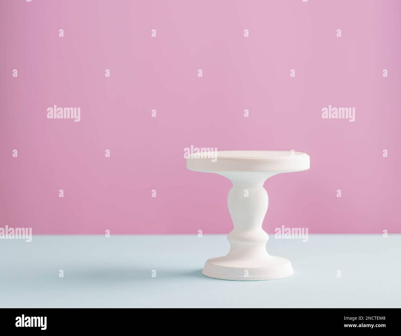 Empty white stand for a birthday cake on a pink plain background Stock ...